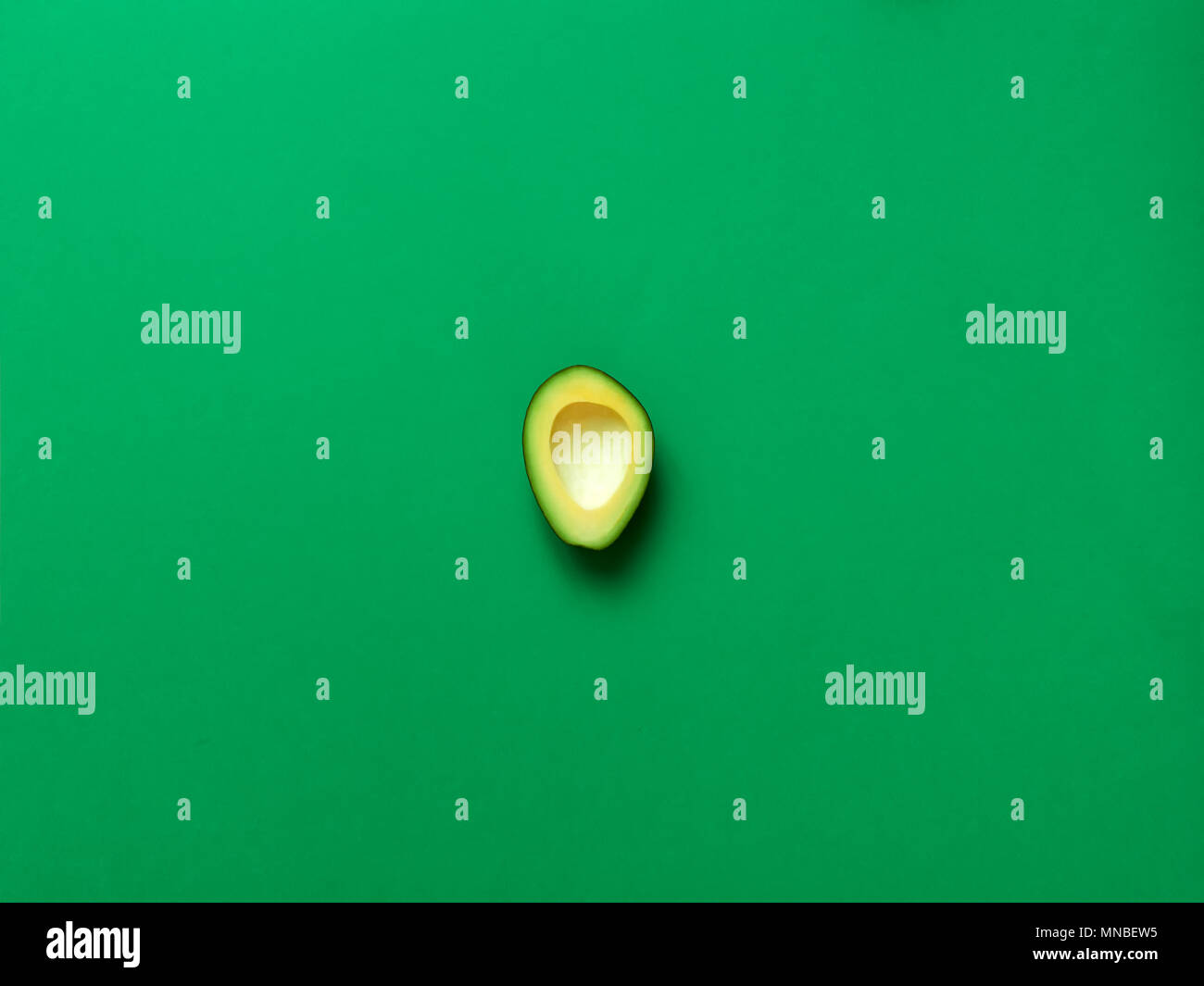 Avocado without seed isolated in green background viewed from above ...