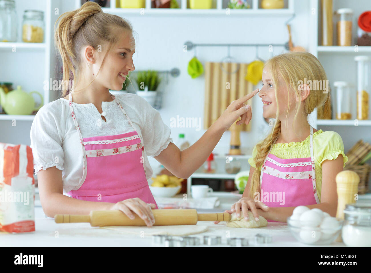 two sisters in the kitchen Stock Photo - Alamy