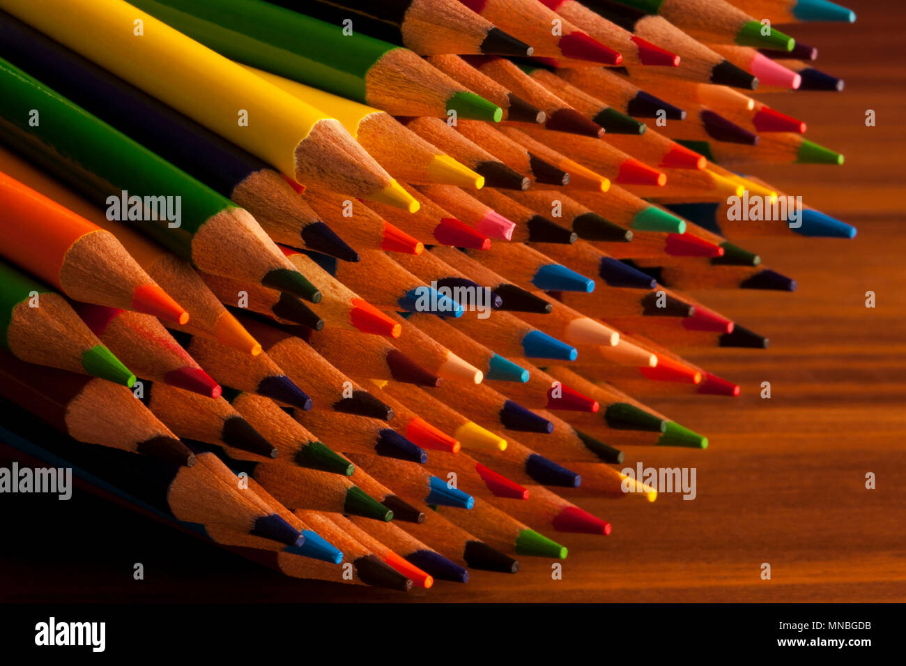 Close-up of multicolored pencils with design elements in rows stacked ...