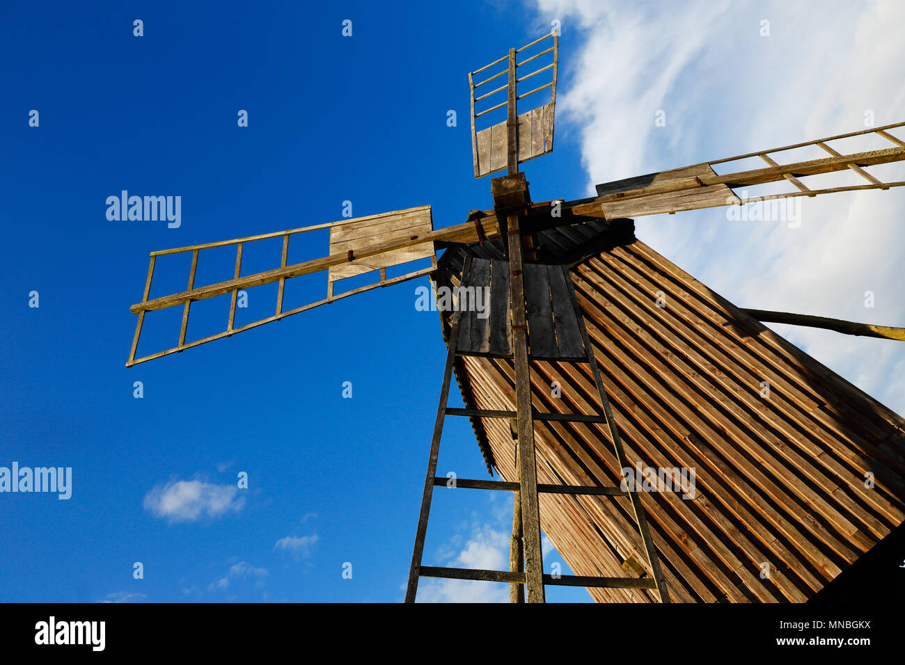 A low angle view of an old brown wooden windmill Stock Photo - Alamy