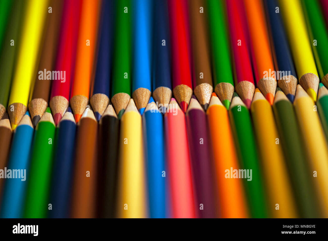 Multicolored pencils in rows creating a rainbow of colors Stock Photo ...