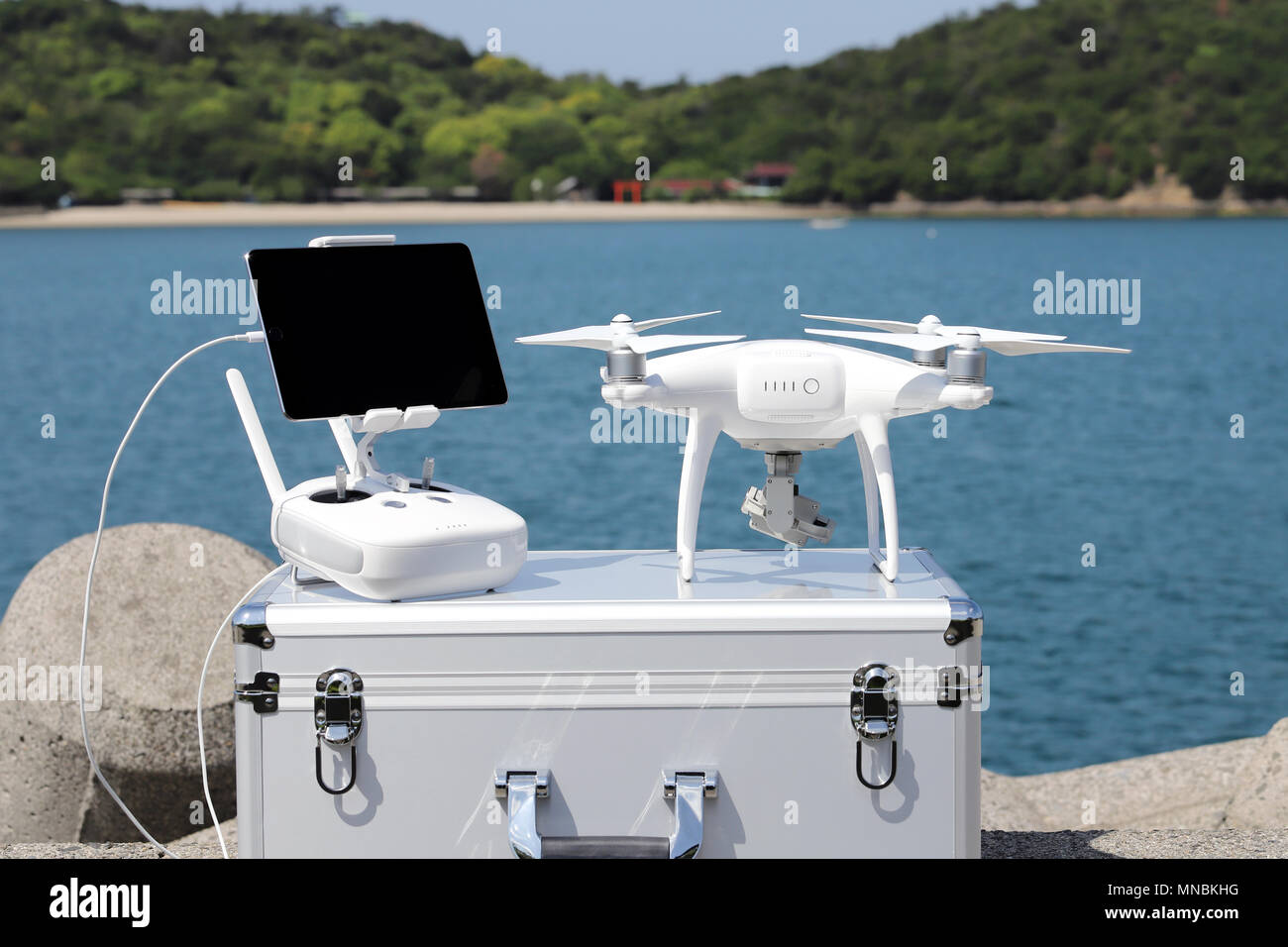 white drone and remote controller before the flight, tool for aerial ...