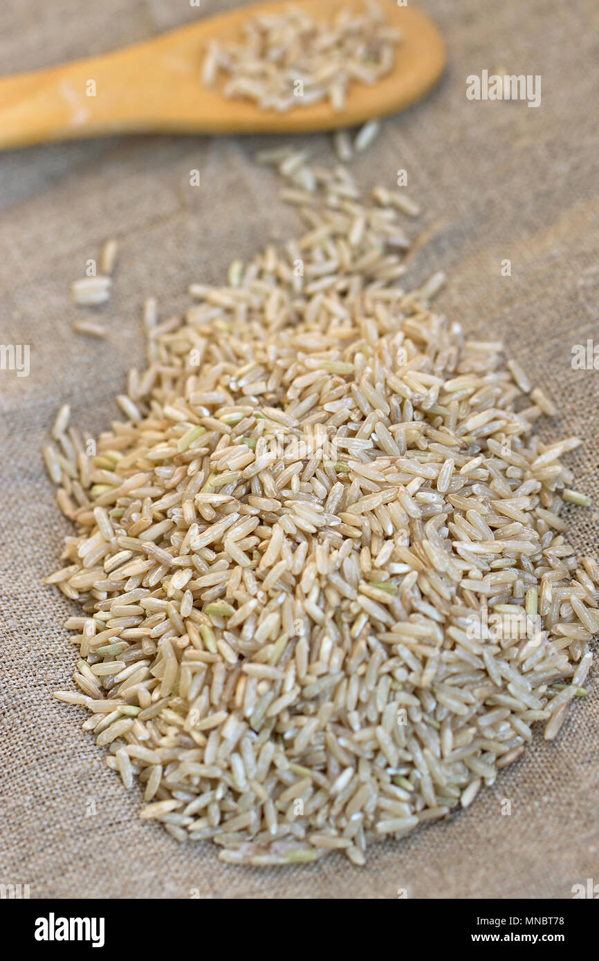 Raw brown rice and wooden spoon Stock Photo - Alamy