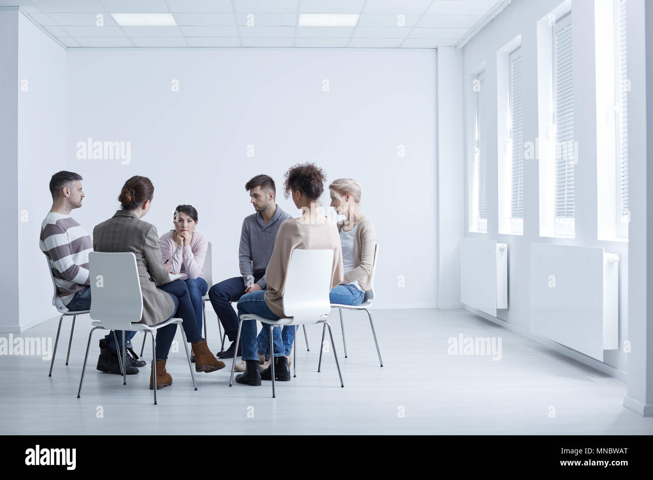 People sitting in circle during AA group meeting Stock Photo - Alamy
