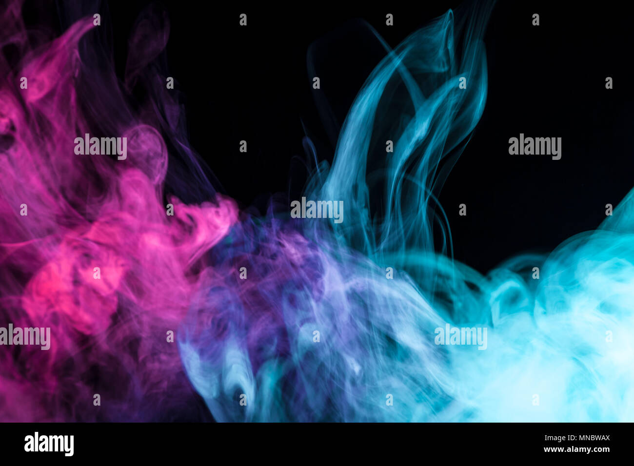 Colorful blue, pink and red smoke on a black isolated background ...