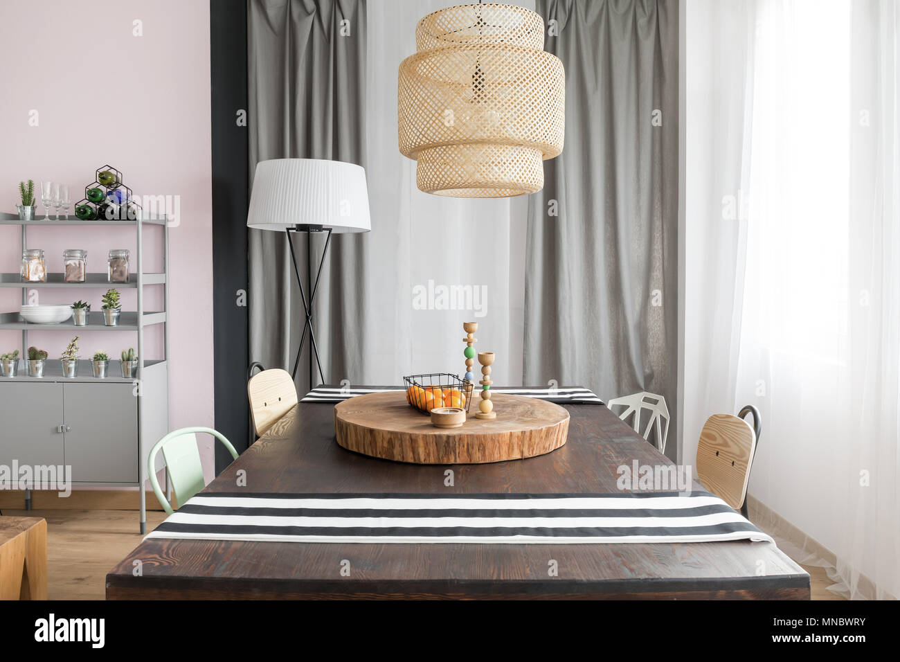 Interior with dining table, lamp and rack Stock Photo - Alamy