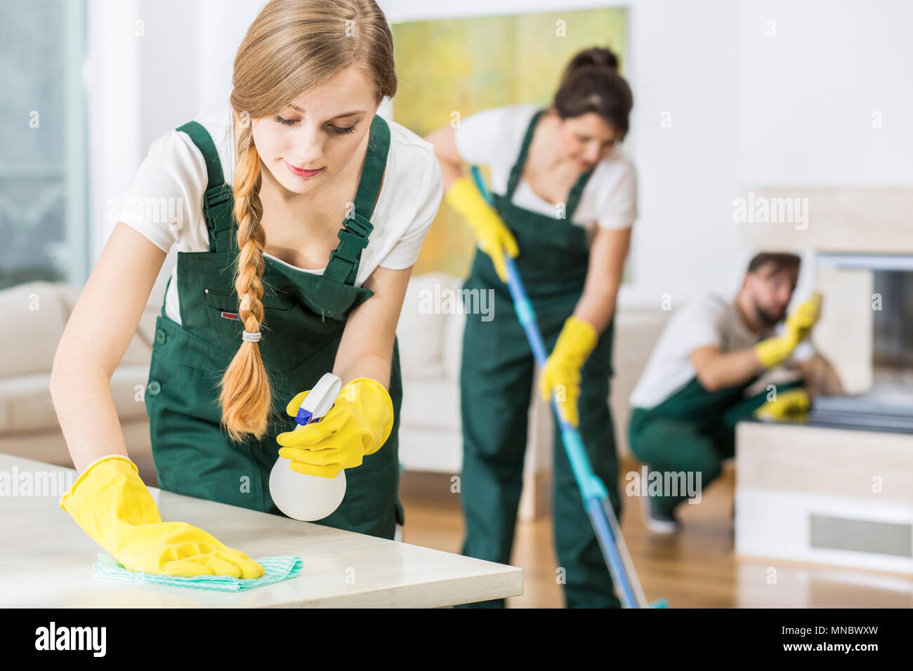 Professional cleaning service in uniforms during work Stock Photo - Alamy