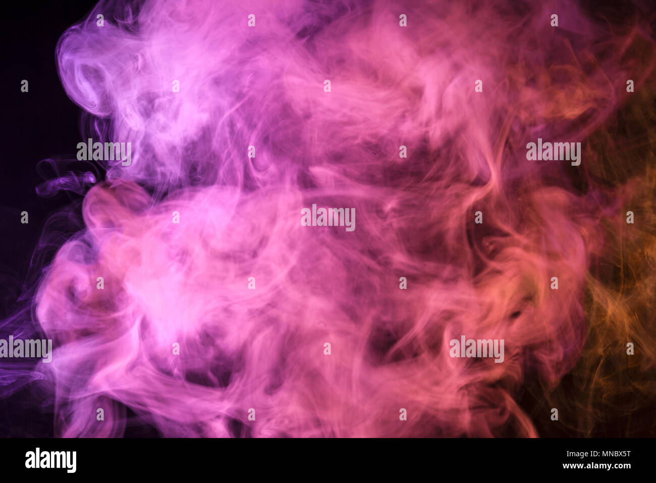 Yellow and pink cloud of smoke of black isolated background. Background ...