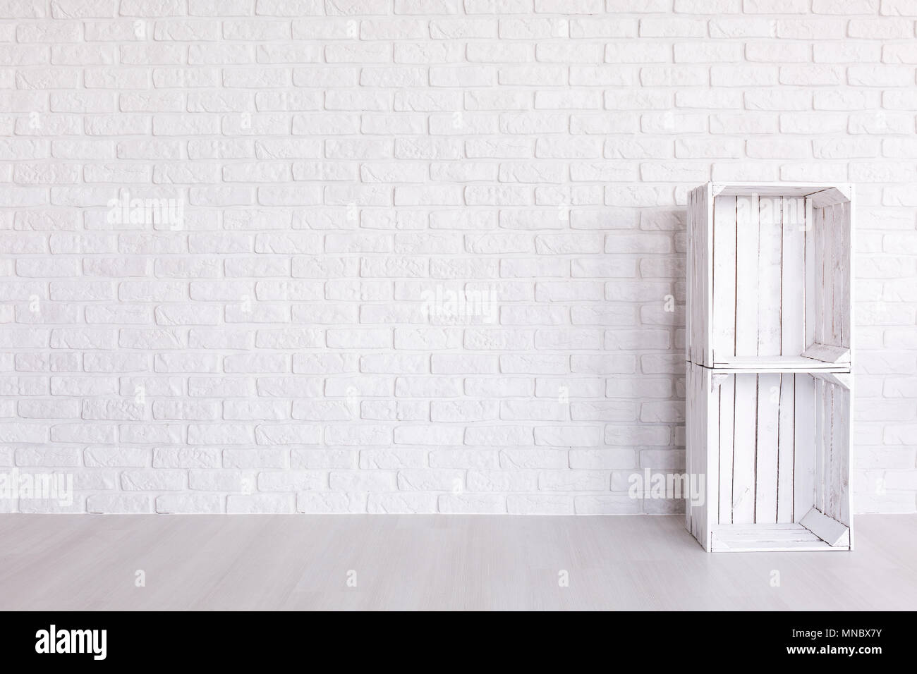 Shot of a white modern room with two boxes and a brick wall Stock Photo ...
