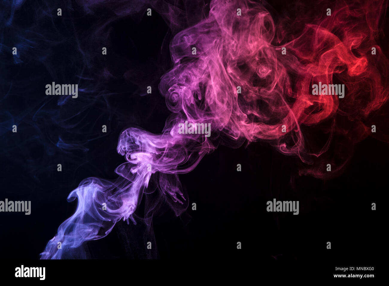 Blue, red and pink cloud of smoke of black isolated background ...