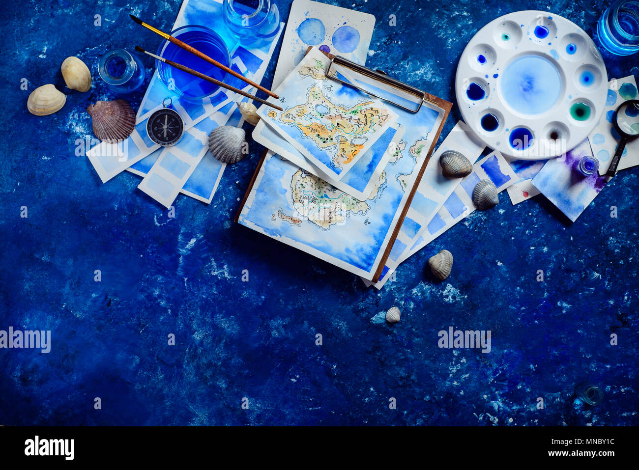 Handpainted fantasy map on a navy blue background with copy space ...