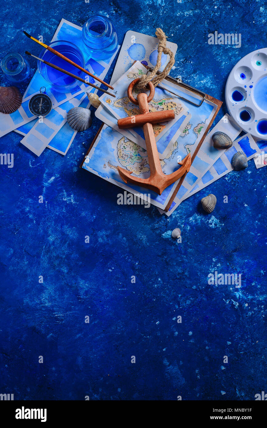 Travel flat lay with wooden anchor, fantasy map, watercolor sketches ...