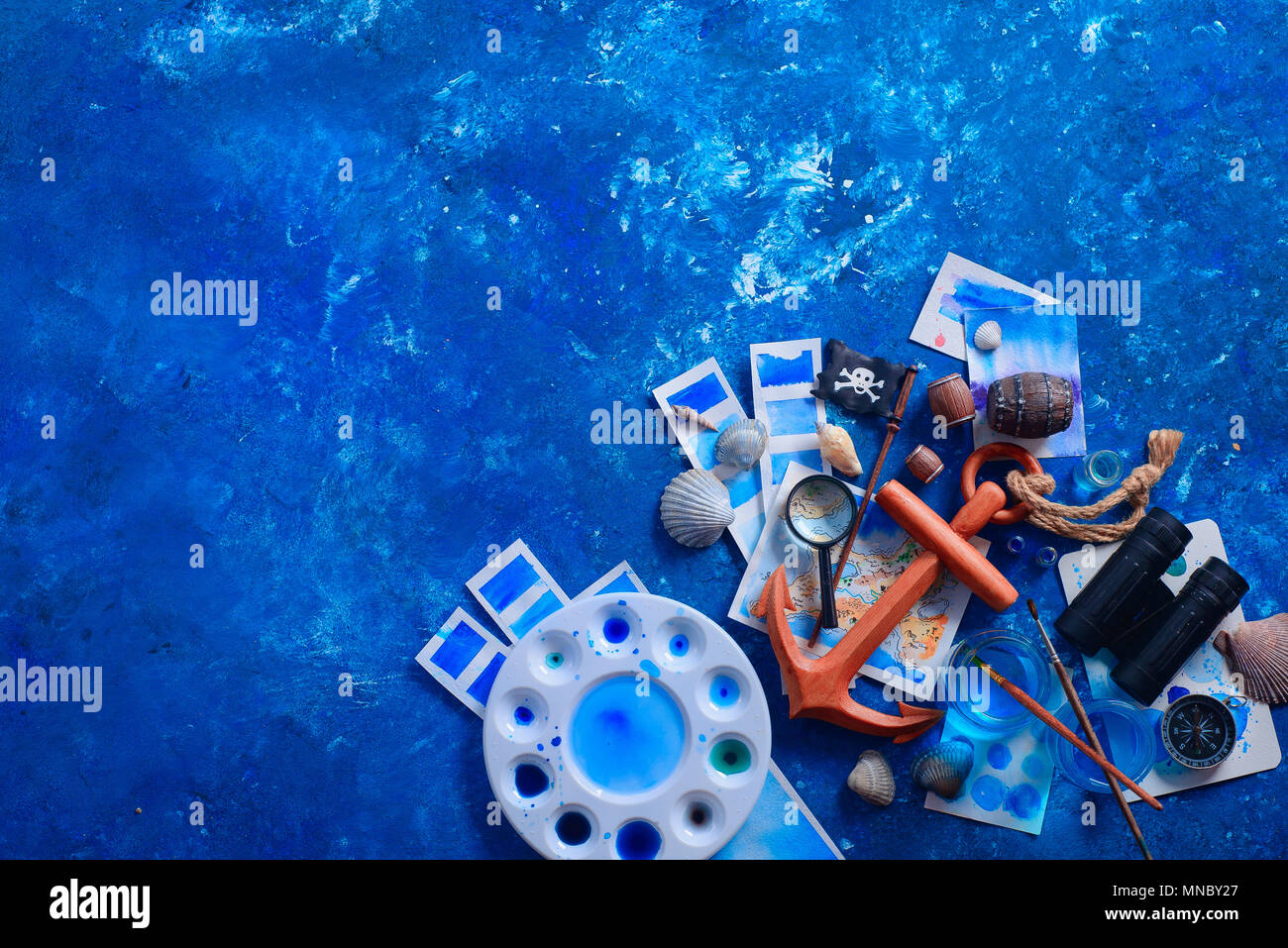 Travel flat lay with wooden anchor, fantasy map, watercolor sketches ...