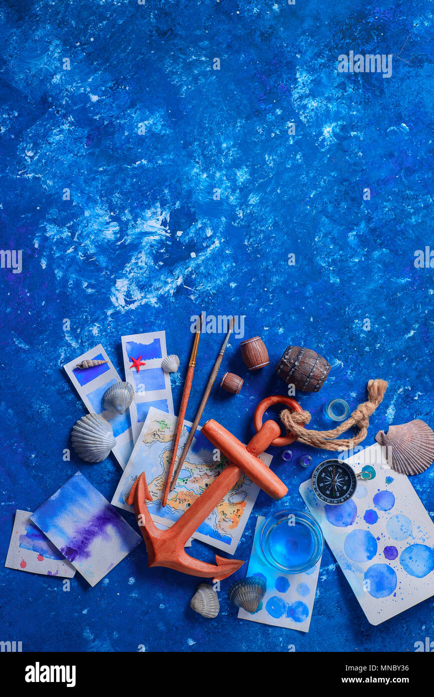 Travel flat lay with wooden anchor, fantasy map, watercolor sketches ...