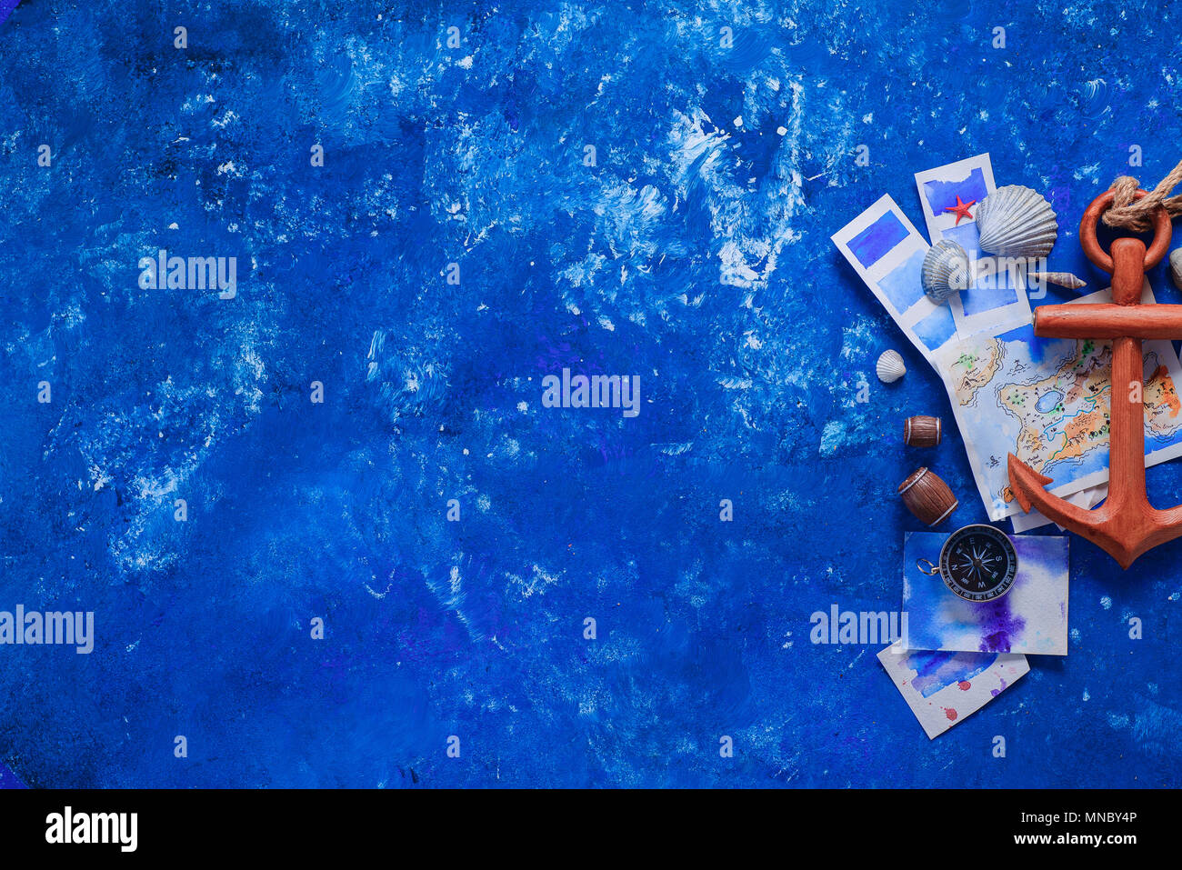 Travel flat lay with wooden anchor, fantasy map, watercolor sketches ...