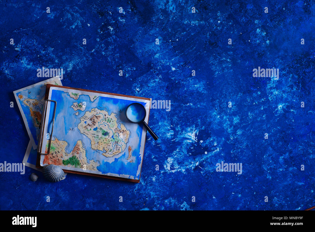 Handpainted fantasy map on a navy blue background with copy space ...