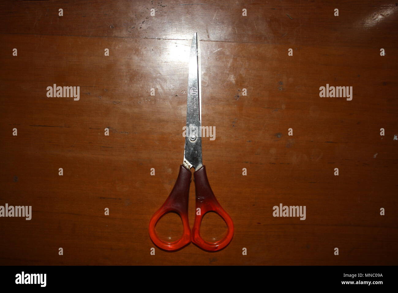 A Scissor with Wood Background Stock Photo - Alamy