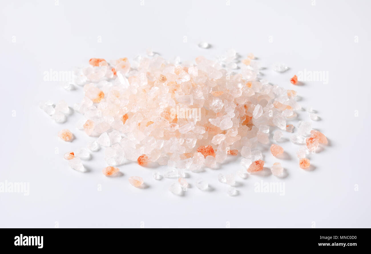 pile of coarse grained salt on white background Stock Photo - Alamy