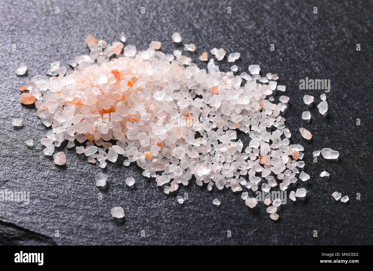 pile of coarse grained salt on black background Stock Photo - Alamy