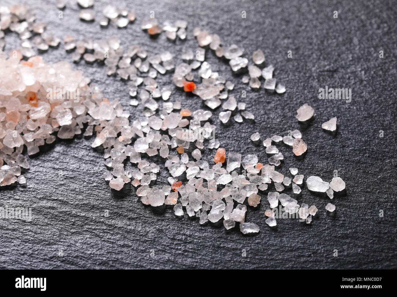 coarse grained salt crystals on black background Stock Photo - Alamy