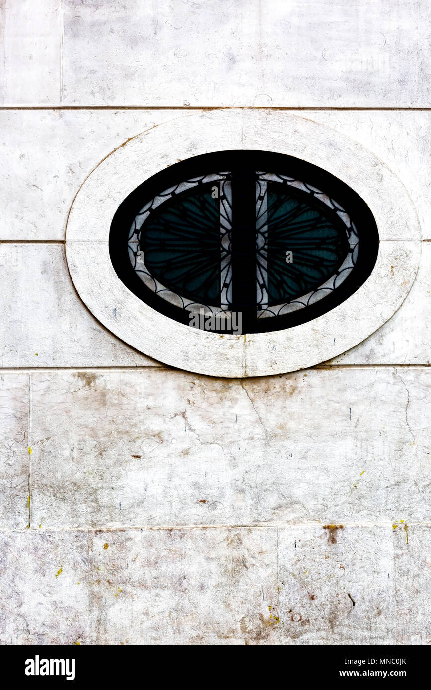 Elliptical stone design with integral black wrought iron grille on wall ...