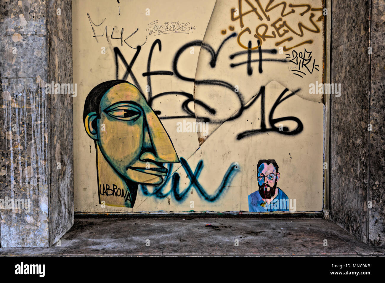 Grafitti on inset wall below street level Stock Photo - Alamy