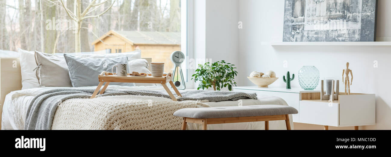 Header of a bright bedroom interior with large window and white ...