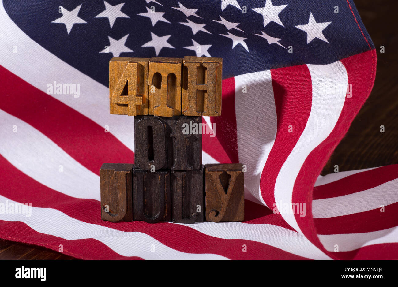 "4th of July" sign using wooden letter blocks on the United States flag ...