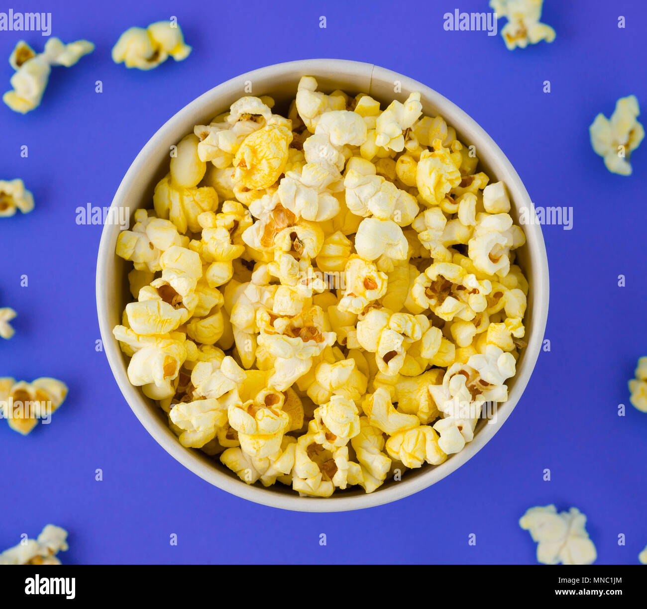 Popcorn in a pack on a blue background Stock Photo - Alamy