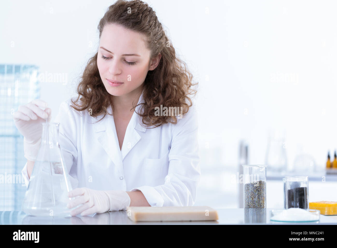 Biotechnologist dissolving the sample in a solution during laboratory ...