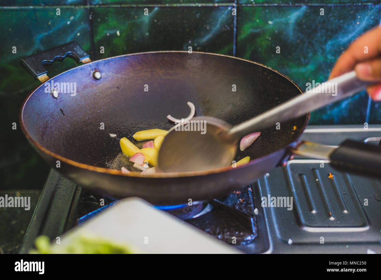Young Asian Woman Cooking on a gas stove in the Kitchen,lifestyle ...