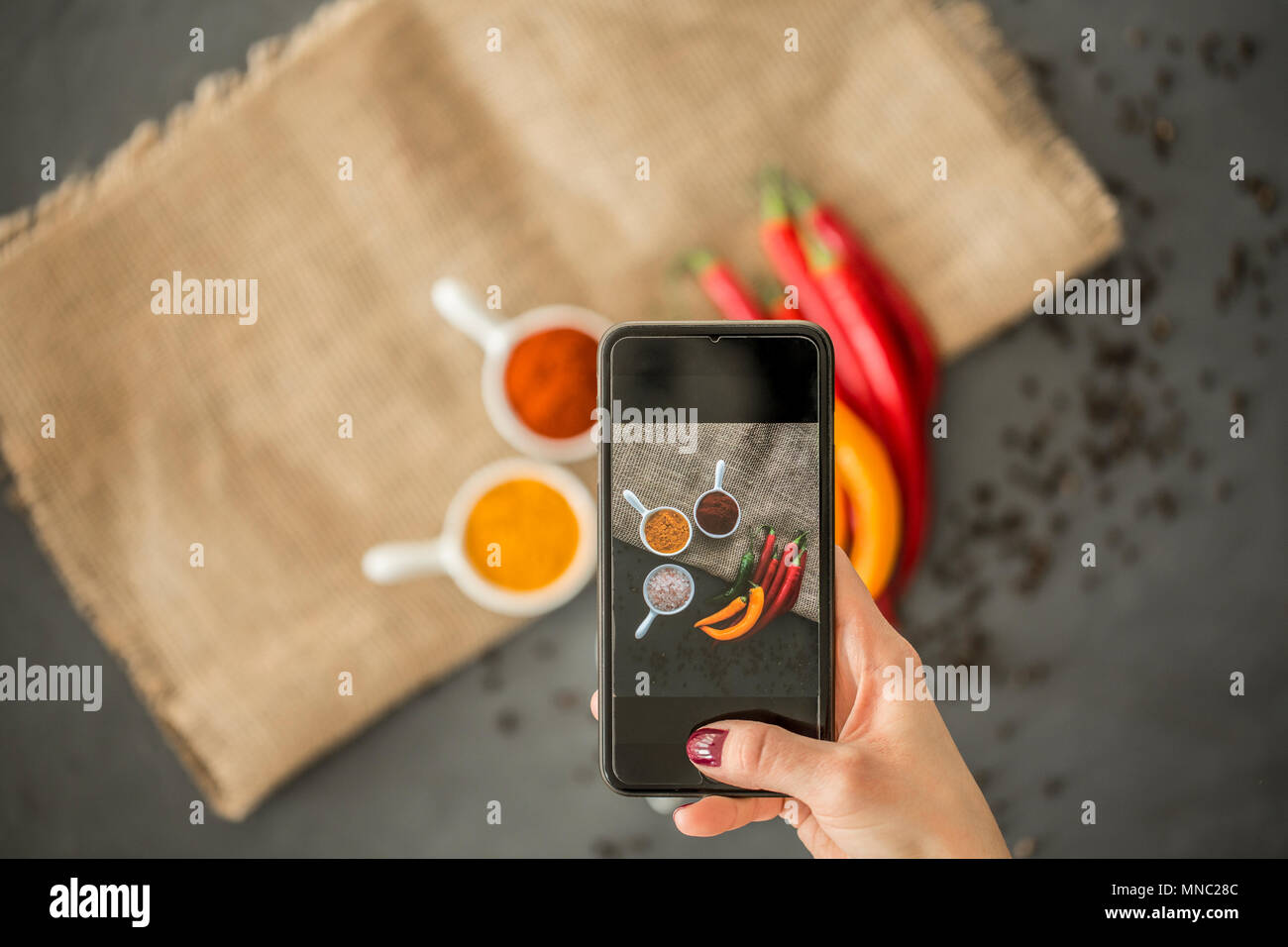 Focus on a woman's hand holding a black phone and using it to take a ...