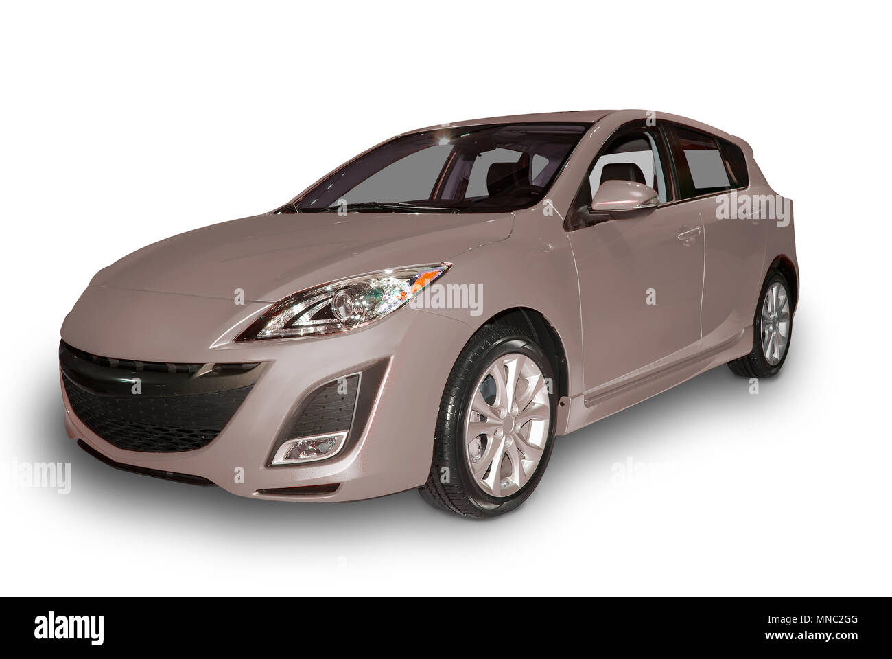 A beige four door compact hybrid car isolated on a white background. A ...