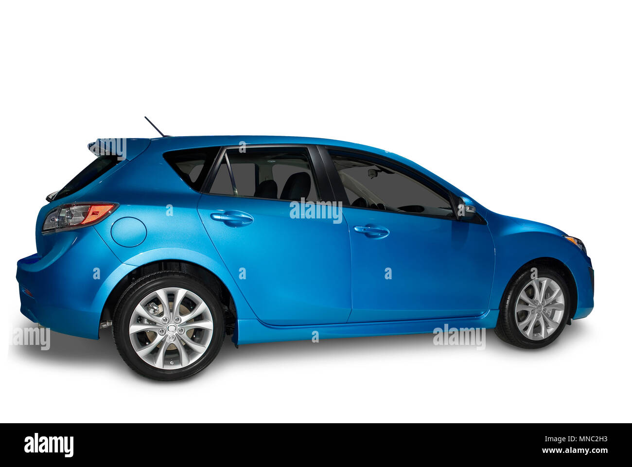 Bright blue four door compact hybrid car isolated on a white background ...