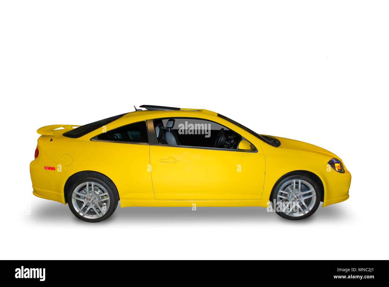 Bright yellow two door compact hybrid car isolated on a white ...