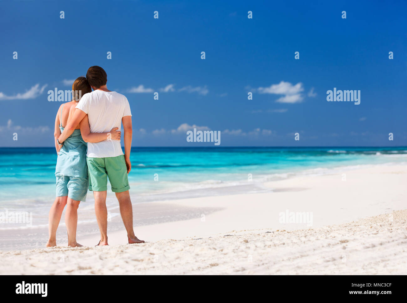 Back view of a couple on a tropical beach at Caribbean Stock Photo - Alamy