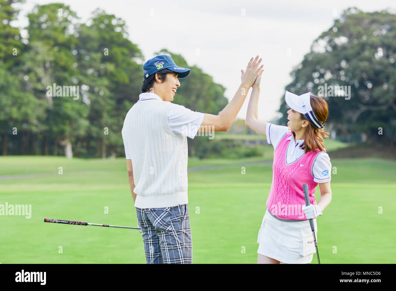 Japanese golf players on course Stock Photo - Alamy
