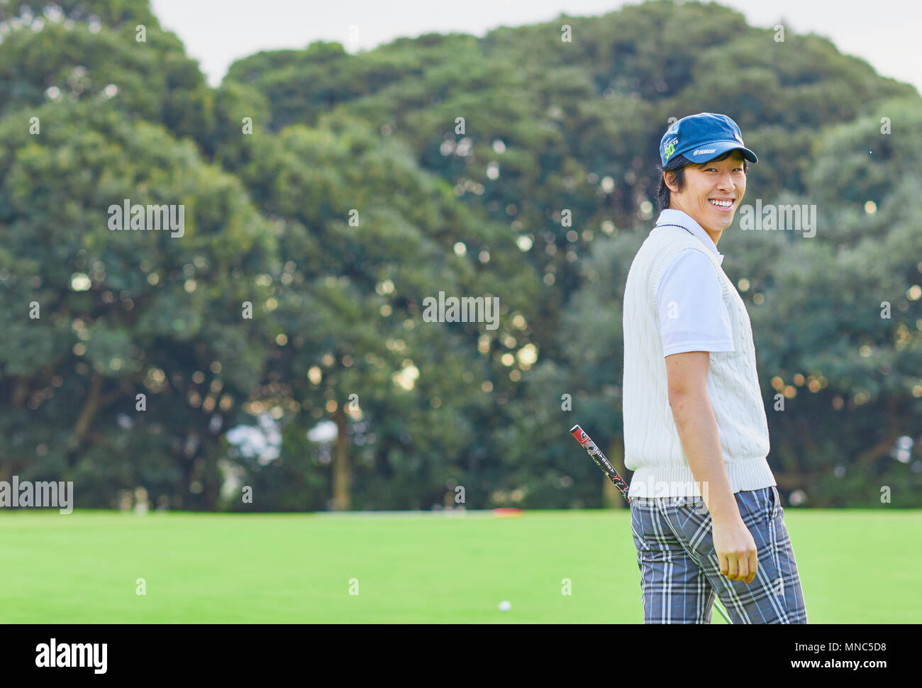 Japanese golf player on course Stock Photo - Alamy