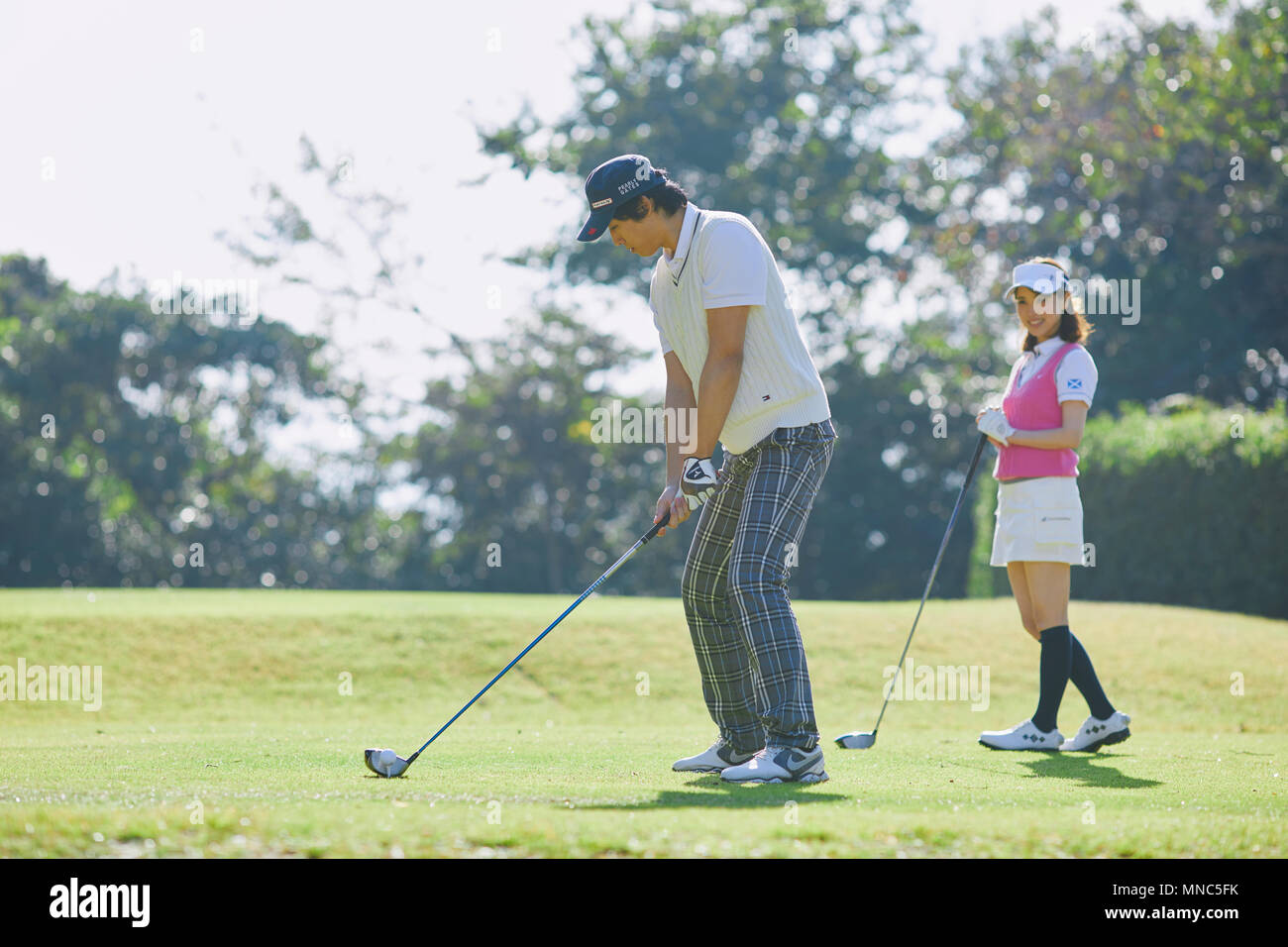 Japanese golf players on course Stock Photo - Alamy