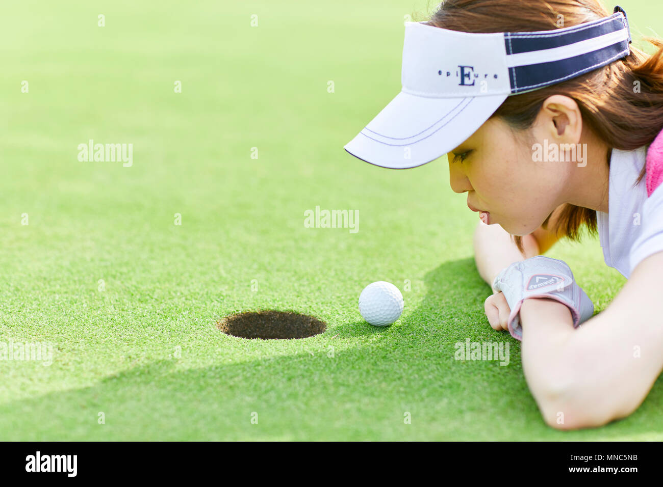 Japanese golf player on course Stock Photo - Alamy