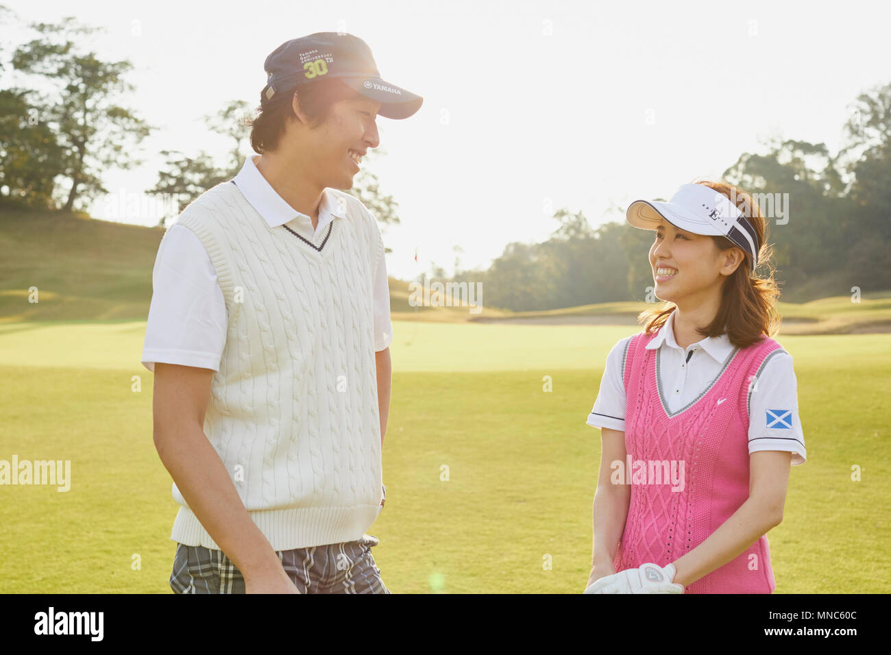 Japanese golf players on course Stock Photo - Alamy