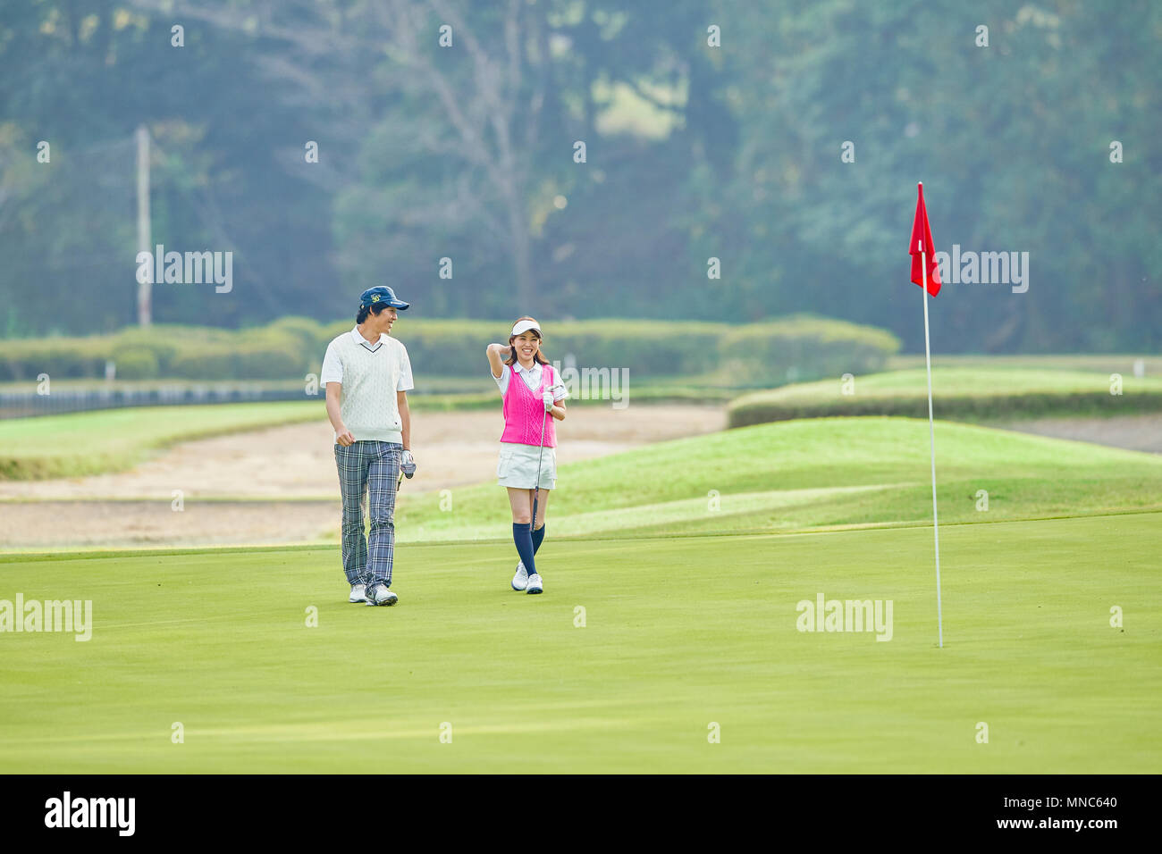 Japanese golf players on course Stock Photo - Alamy
