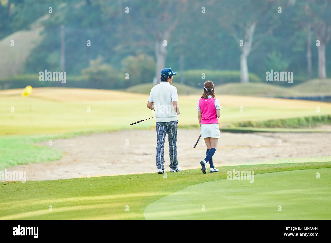 Japanese golf players on course Stock Photo - Alamy
