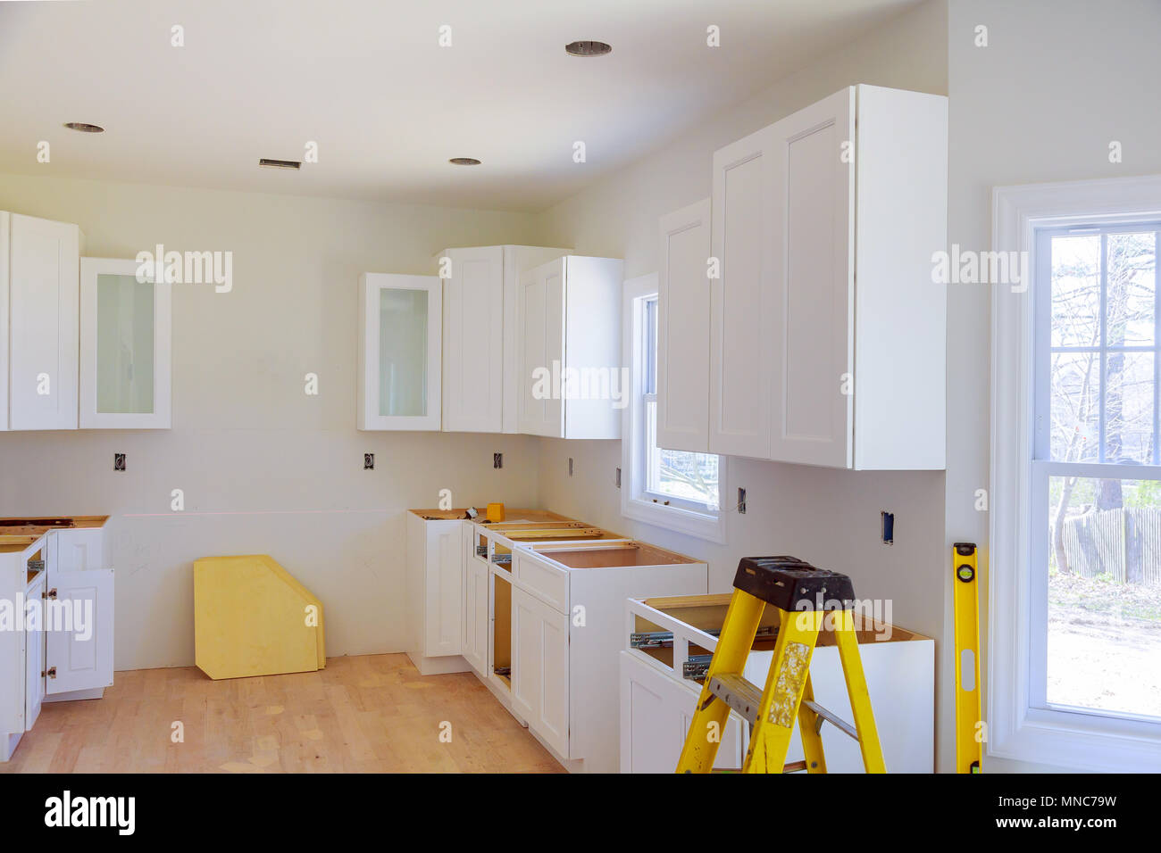 Installed wood kitchen cabinets with modern of installs cabinet Stock Photo - Alamy