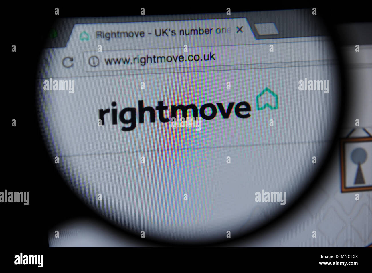 The rightmove real estate website seen through a magnifying glass Stock ...