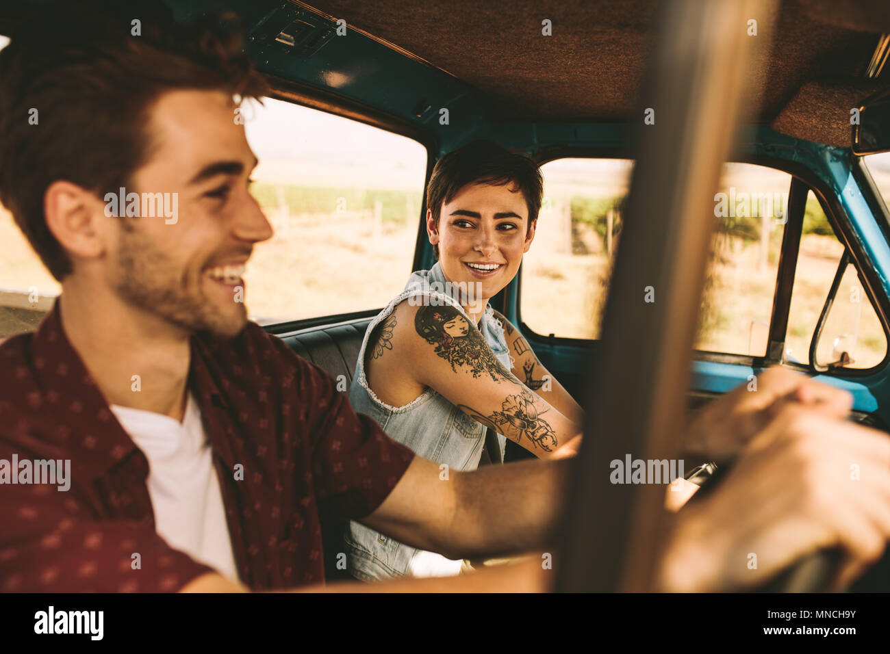 Friends on a road trip talking in car hi-res stock photography and ...