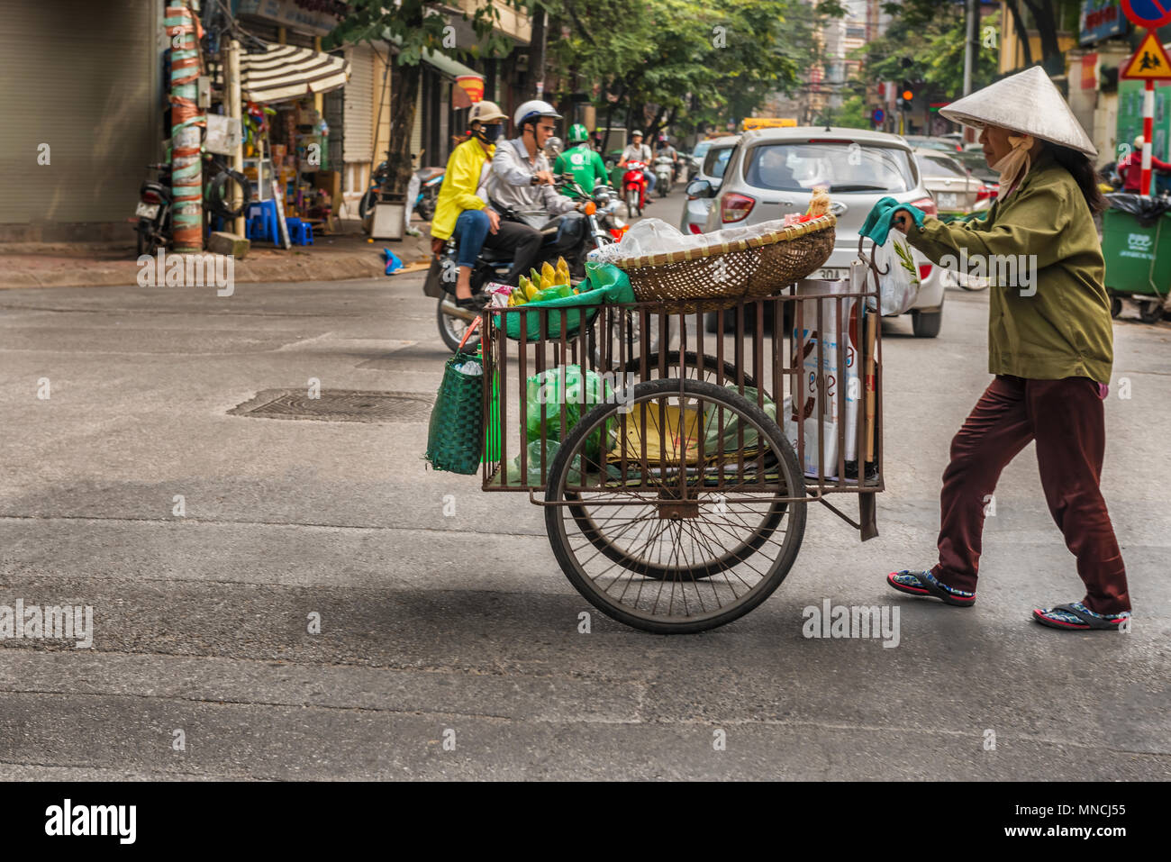 Hanoi, Vietnam - October 27, 2017: Street vendor in Hanoi is pushing ...