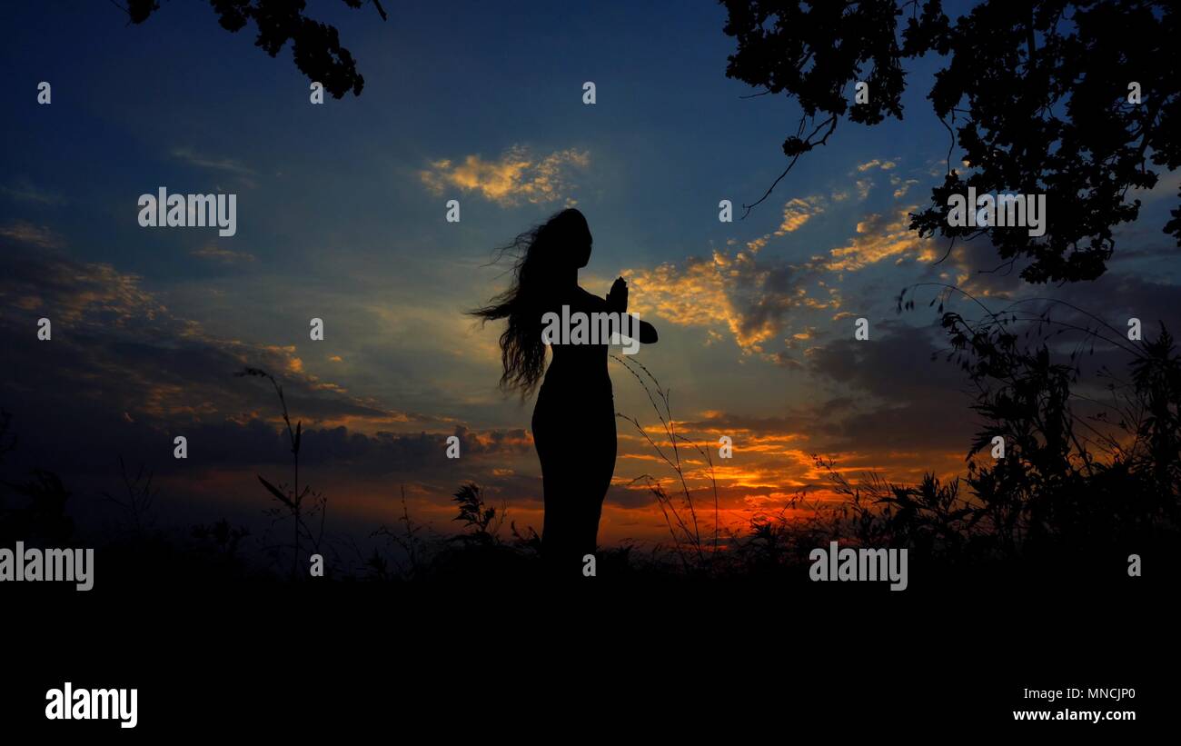 Black shadow female silhouette praying in evening sky background Stock ...