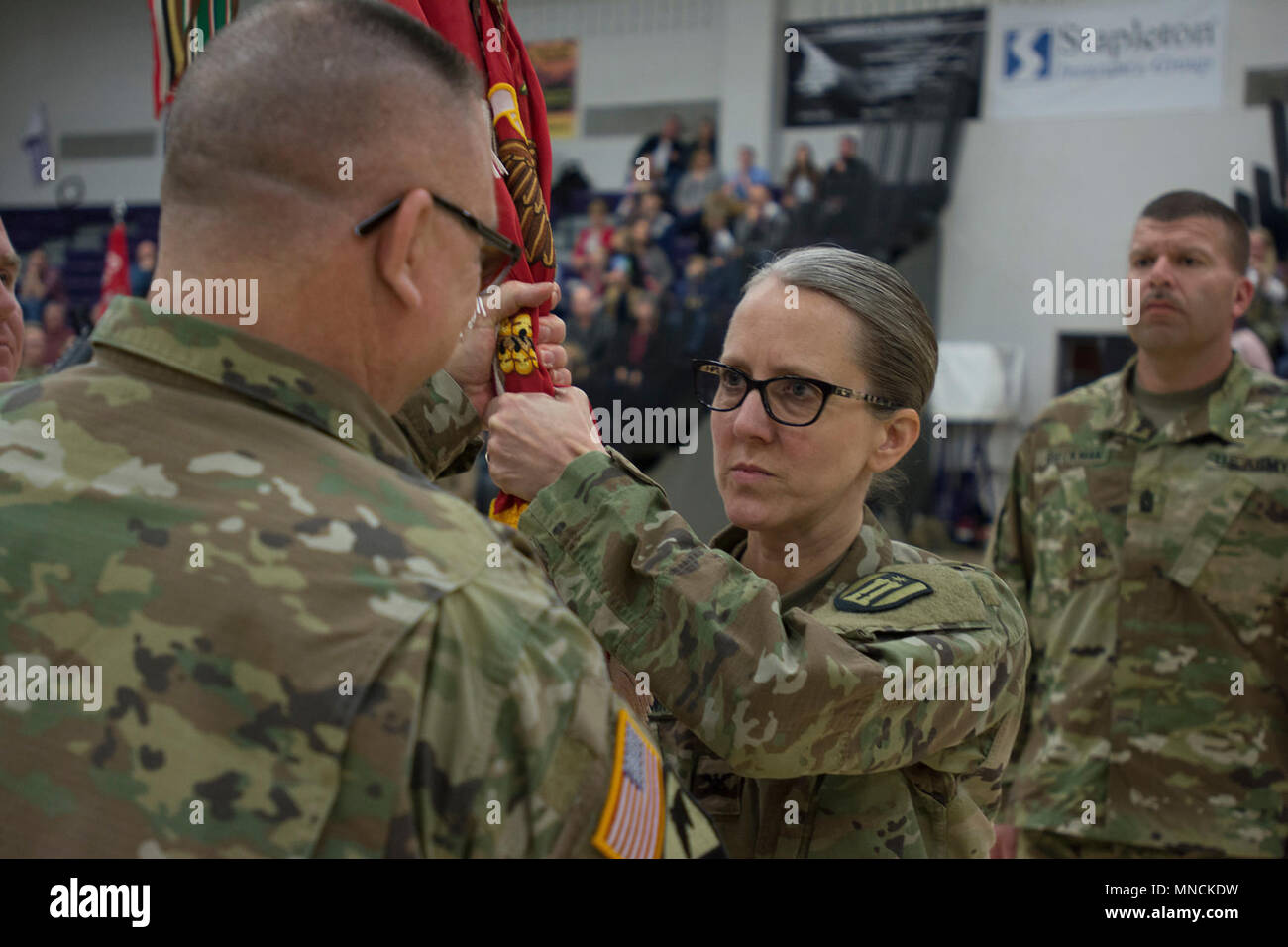 Col. Michelle Link, commander of the 372nd Engineer Brigade, hands the ...