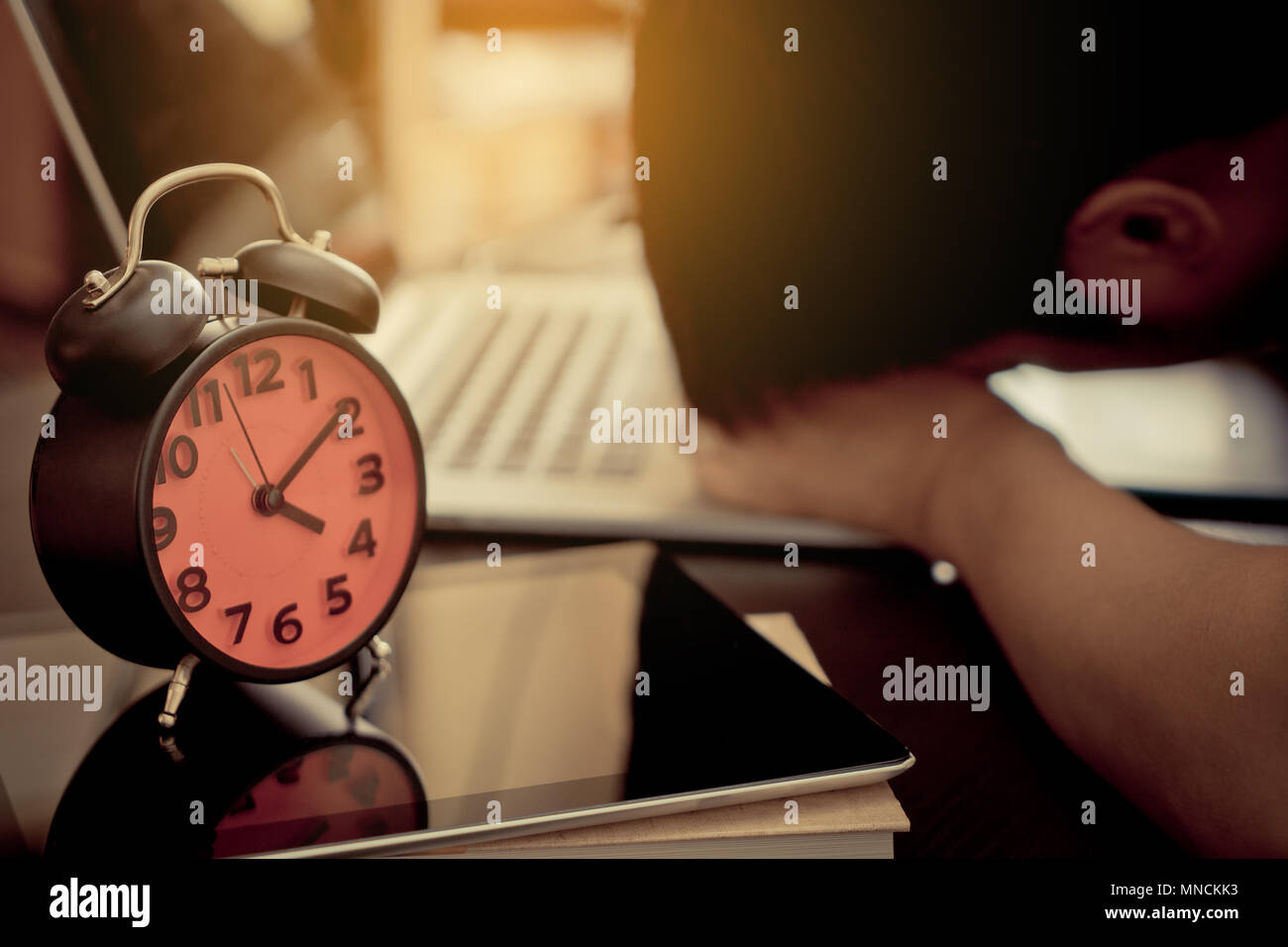 Stressed out person with clock counting to deadline Stock Photo - Alamy